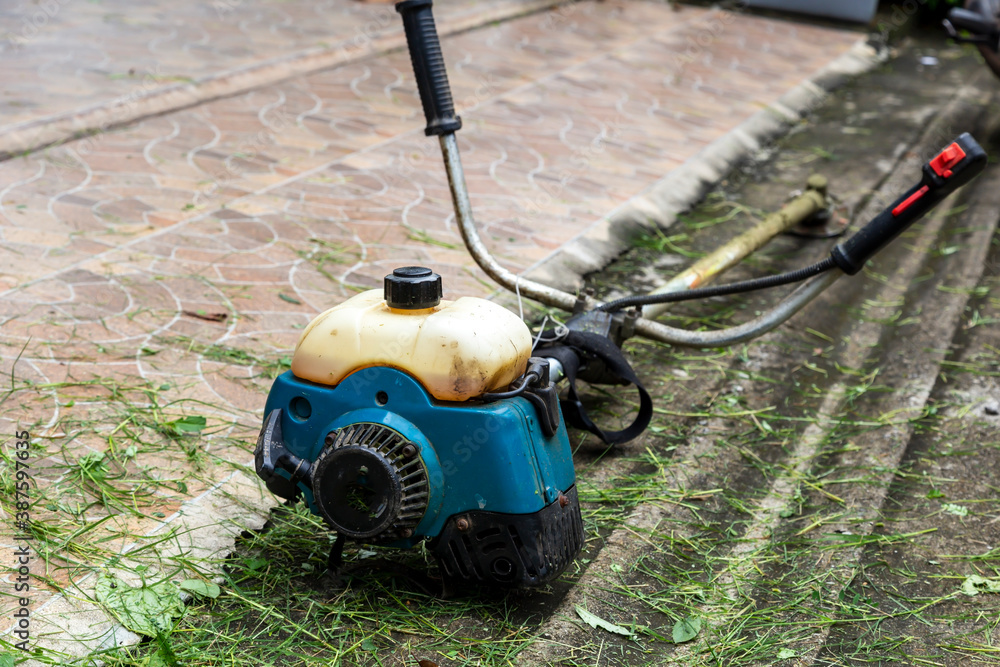 Shoulder mower is placed on the concrete floor after use. Stock Photo ...