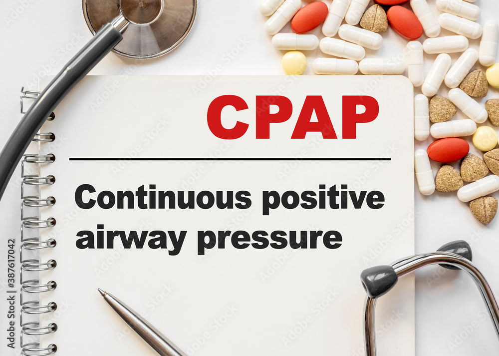 Page in notebook with CPAP Continuous positive airway pressure on white ...