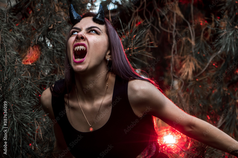 woman on Halloween shows the inner demon. scream of evil in the street ...
