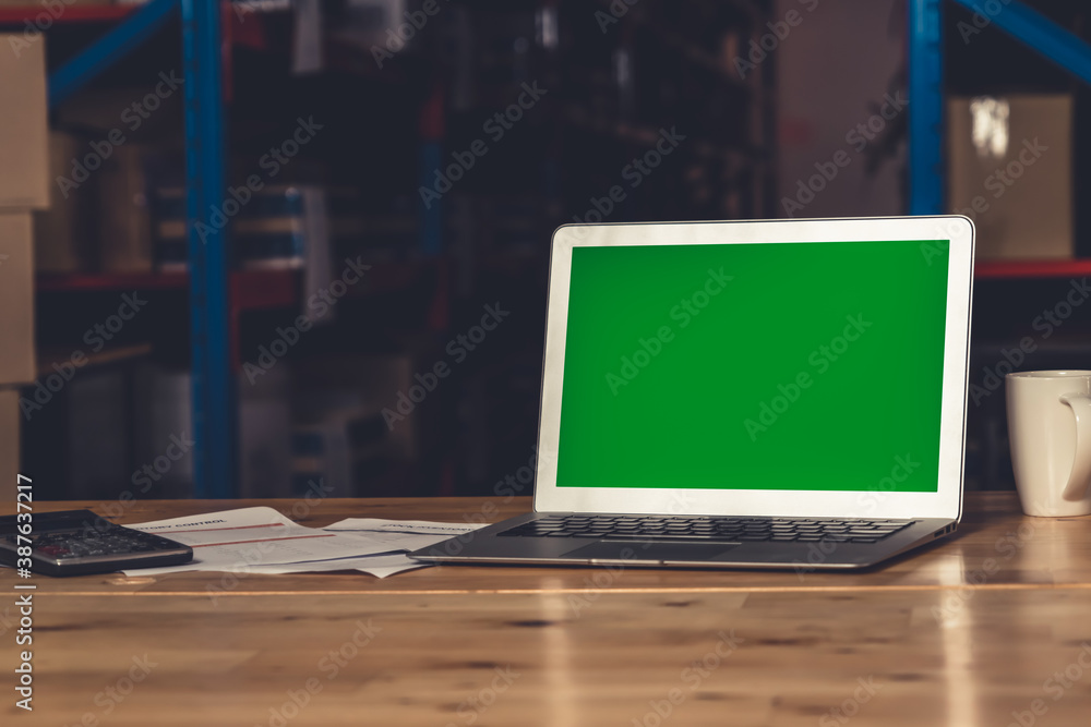 Computer with green screen display in warehouse storage room . Delivery ...