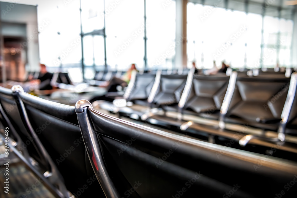 Airport interior with black trash can garbage bin in foreground and ...
