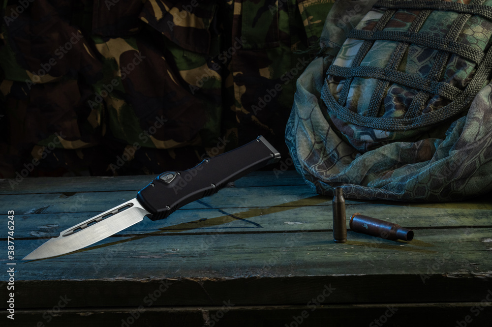 Sharp knife and cartridges. Army uniform, knives and casings. Stock ...