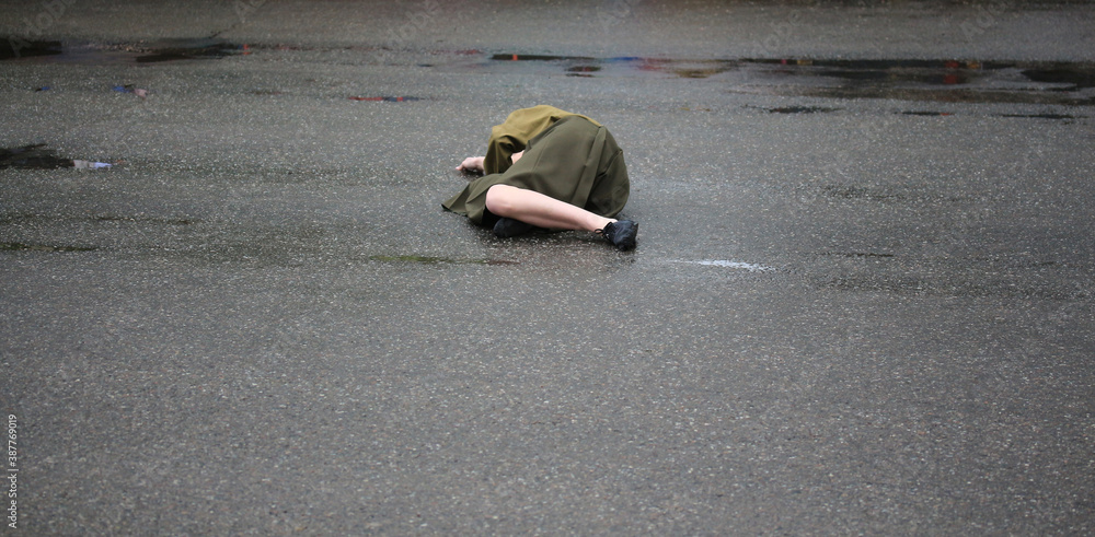 Young woman lying down on ground. Sick or ill girl unconscious outside ...