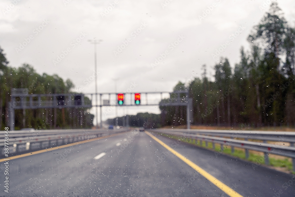 Road view with speed limit signs through windshield car window with ...