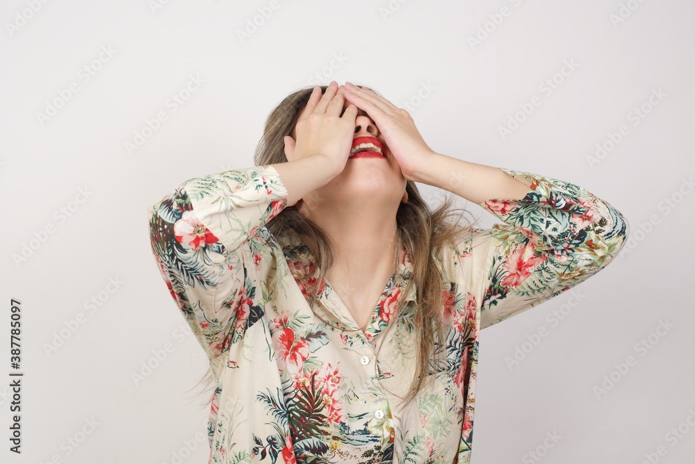 Shocked panic Caucasian girl dressed in stylish clothing holding hands ...