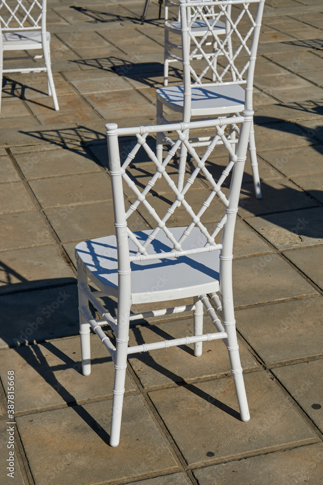 Large group of empty white chairs arranged for social distance, ready ...