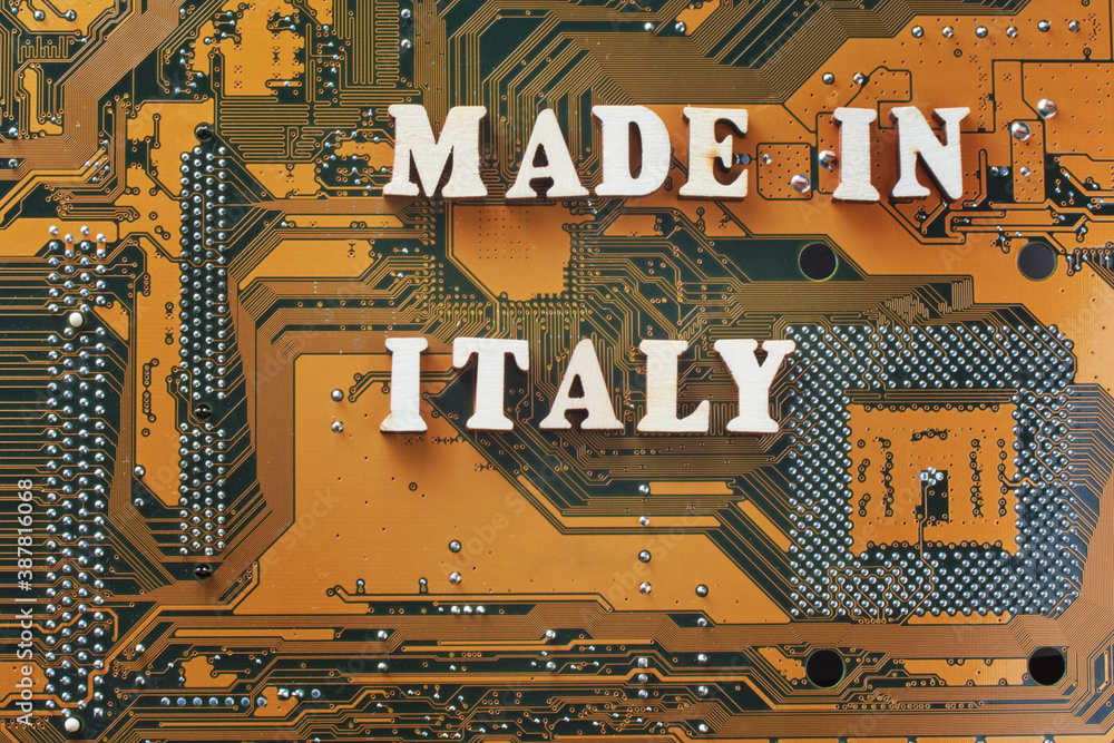 MADE IN ITALY text on gold printed circuit board. Warehouse logistics ...
