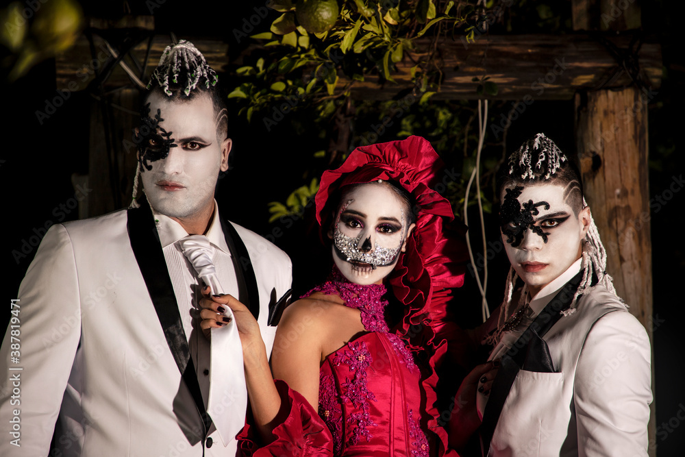 A catrina and two catrin in front of a well at night Stock Photo ...