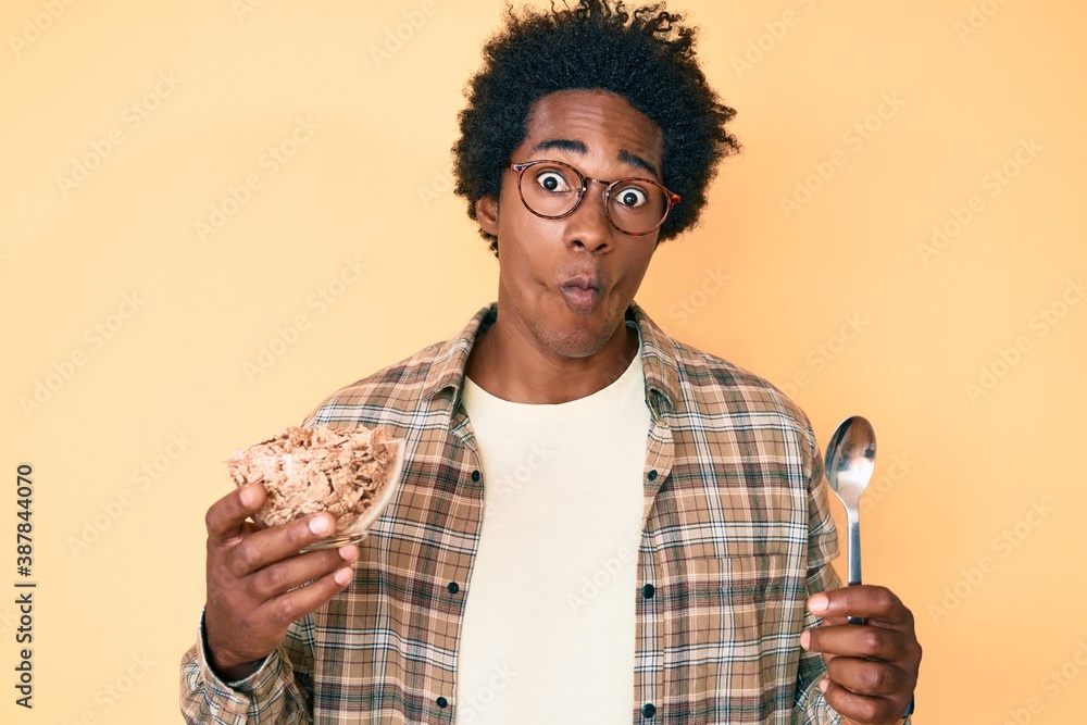 Handsome african american man with afro hair eating healthy whole grain ...