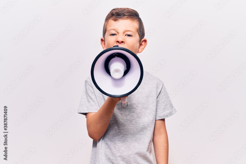 Adorable caucasian kid boy with angry expression. Screaming loud using ...