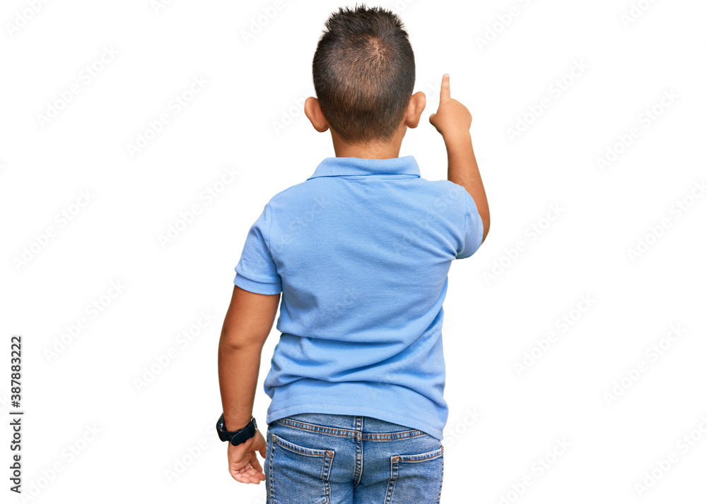Little boy hispanic kid wearing casual clothes posing backwards ...