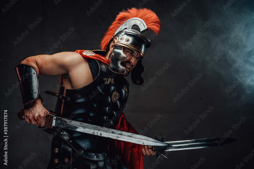 Armoured savage and brutal roman warrior in red cloak with helmet ...