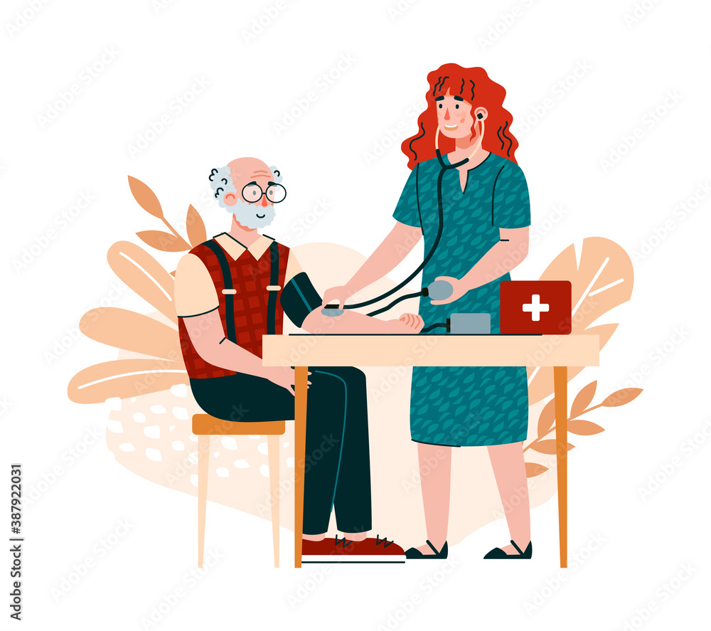 A girl social worker or volunteer measures the pressure of an elderly ...
