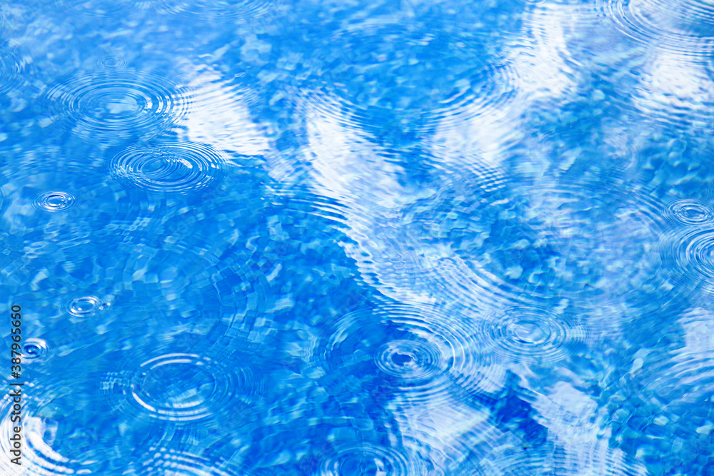 Raindrops on pool blue water surface. Blue water texture as background ...