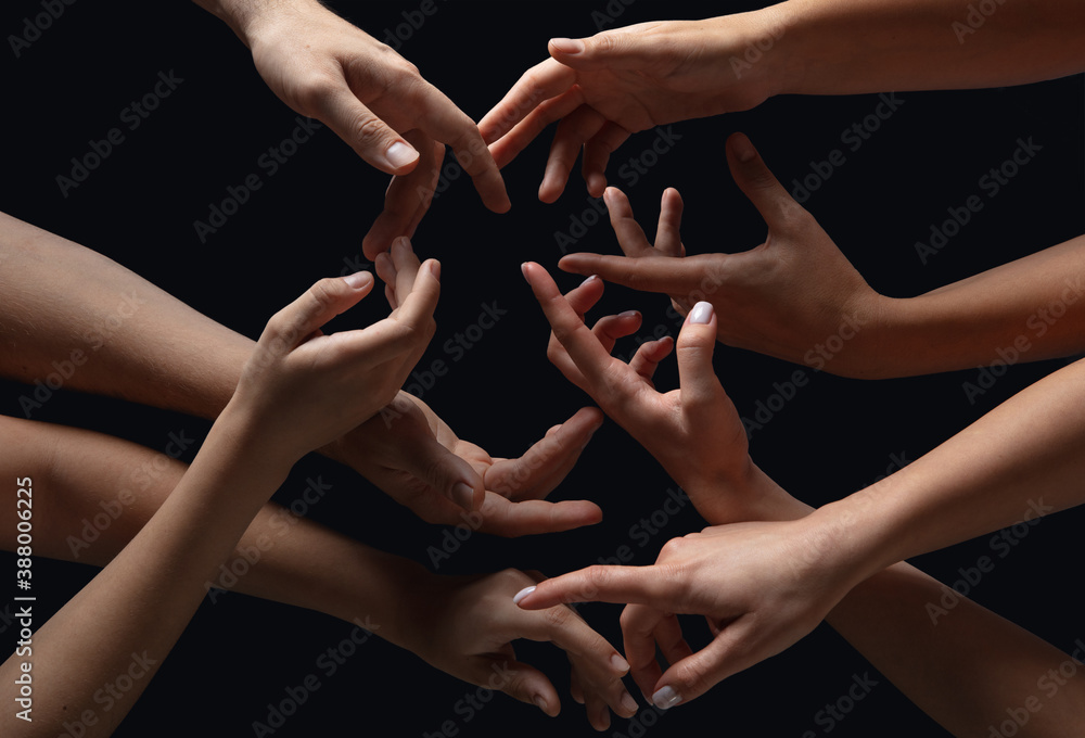 Friendship. Hands of people's crows in touch isolated on black studio ...