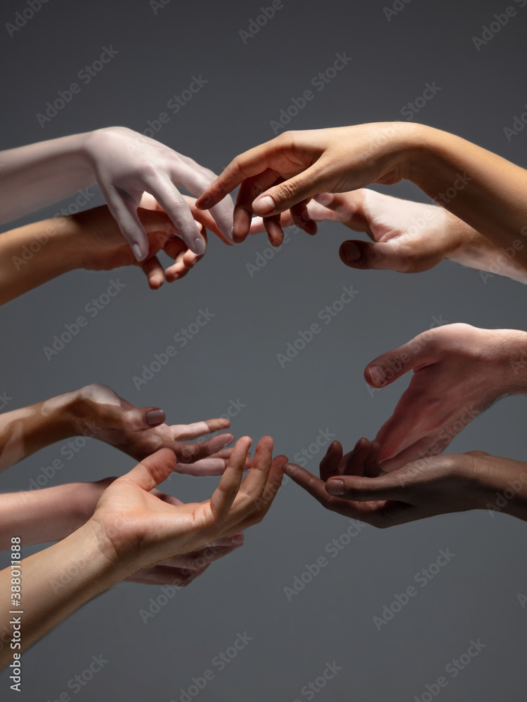 Saving kindness. Hands of different people in touch isolated on grey ...