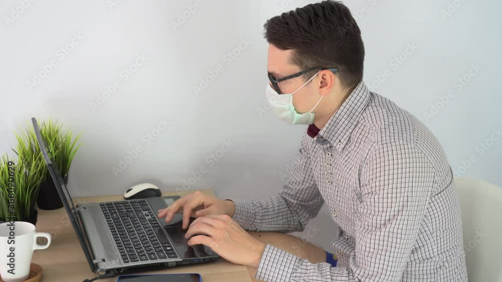 Young infected male businessman in disposable protective face mask ...
