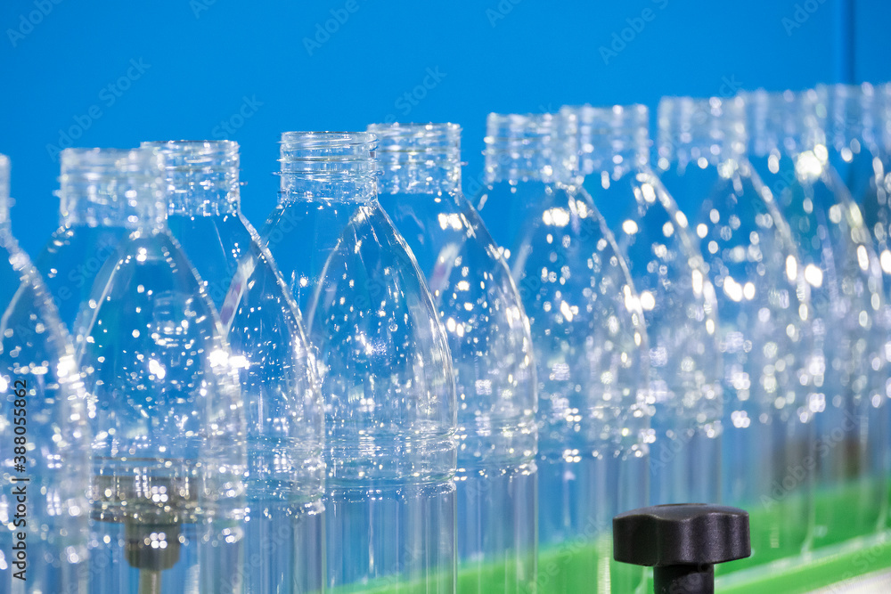 The PET bottles on the conveyor belt for filling process in the ...