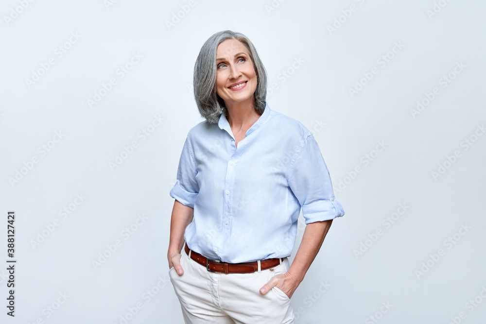 Happy dreamy mature senior business woman looking away at copy space ...