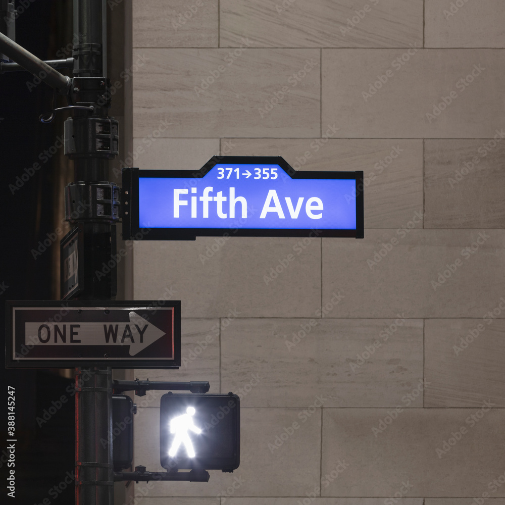 USA, New York, New York City, Fifth Avenue sign and pedestrian lights ...