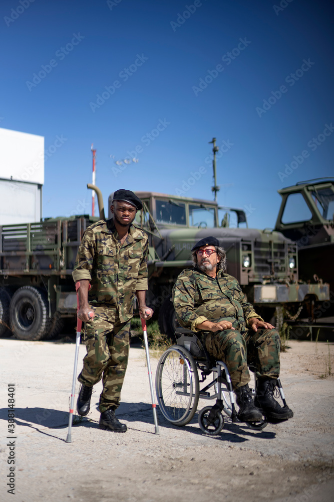 Injured military officer holding crutches while standing with disabled ...