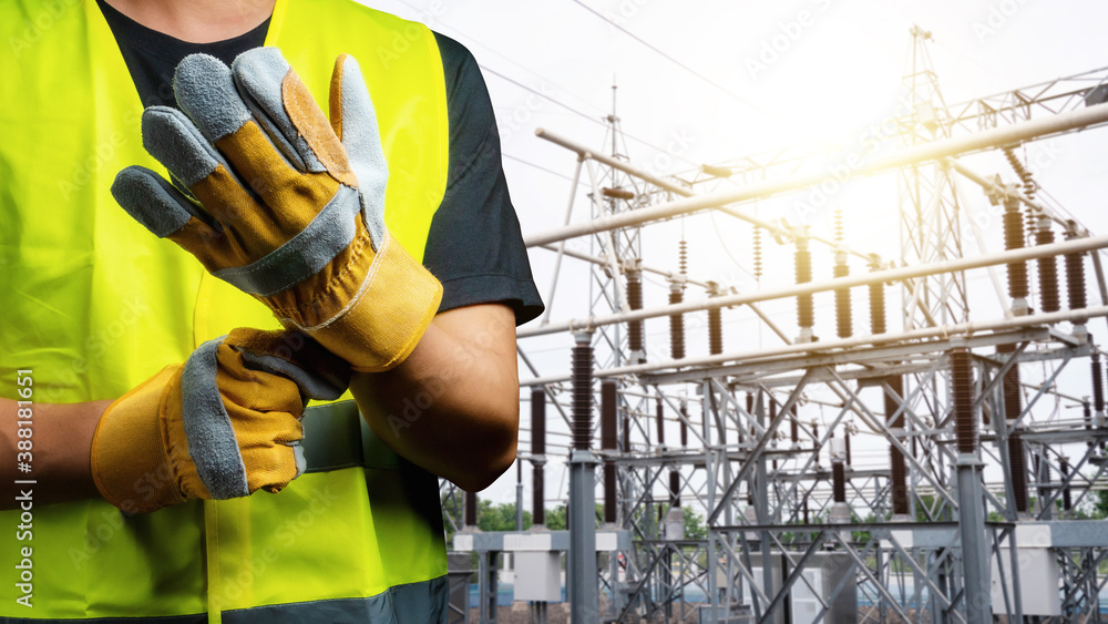 An electrician wearing a black T-shirt and personal protective ...