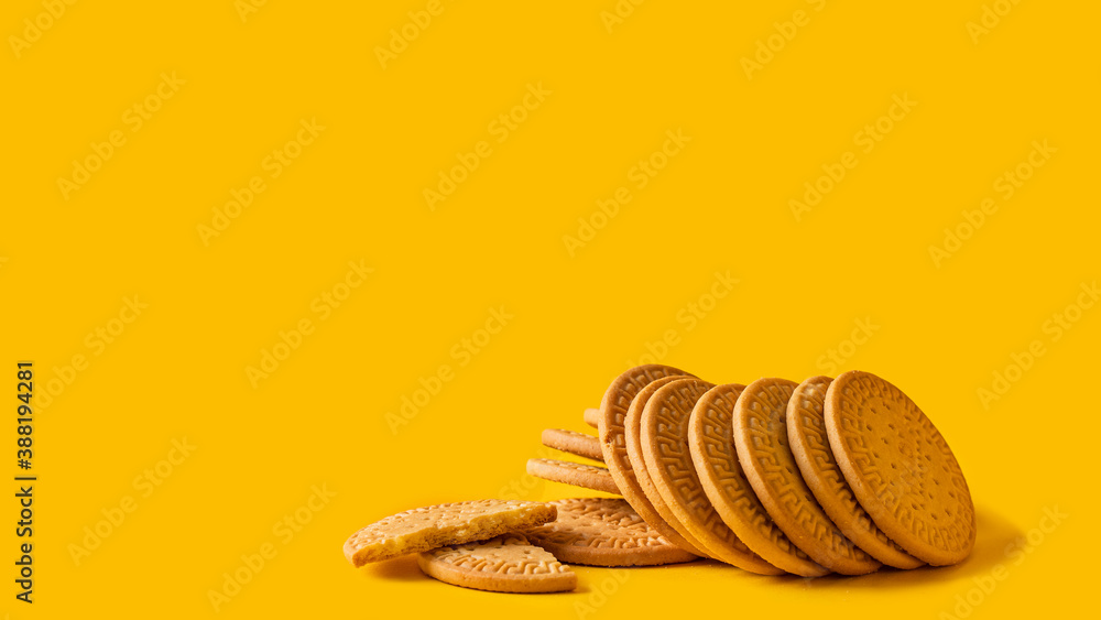 Many Marie biscuits on bright yellow background. Modern cookies concept ...