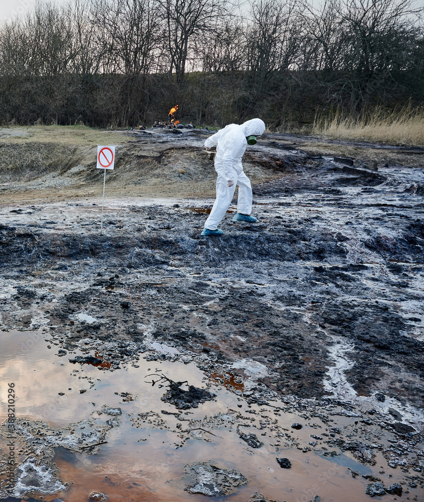 Male worker in white protective suit and gas mask after installing ...