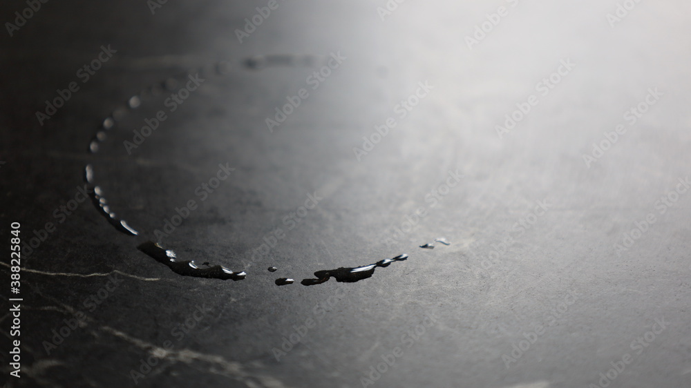 Water stains from glass on a black and white marble table. A ...