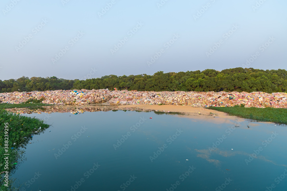 Waste Garbage Landfill. Heap of garbage at a junkyard near the river ...
