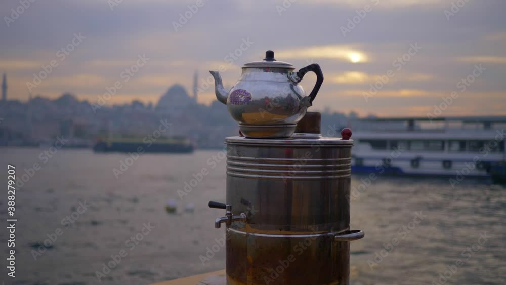 Turkish tea at sunset at Bosphorus, Istanbul skyline and mosques ...