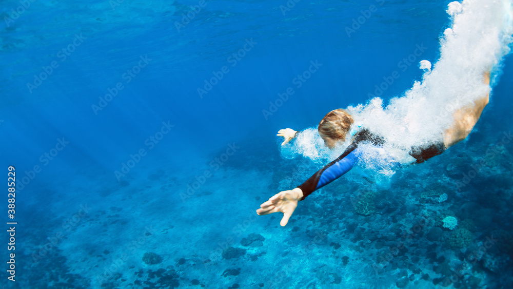 Happy family - active teenage girl jump and dive underwater in tropical ...