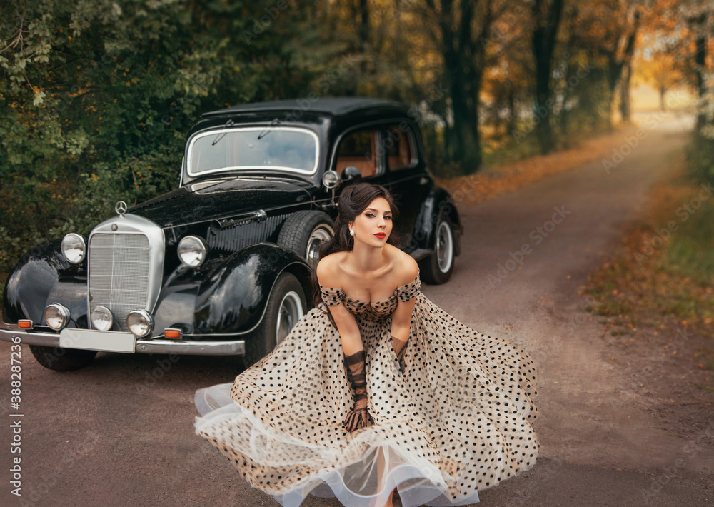 Young beautiful happy retro woman near the old car. Attractive elegant ...