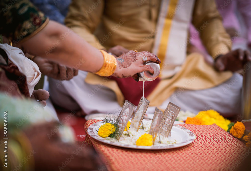 Indian wedding | Bride's Mom pouring milk tradition Stock Photo | Adobe ...