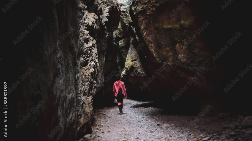 Cavern or cave exploration. Young exlorer walk through narrow paths in ...