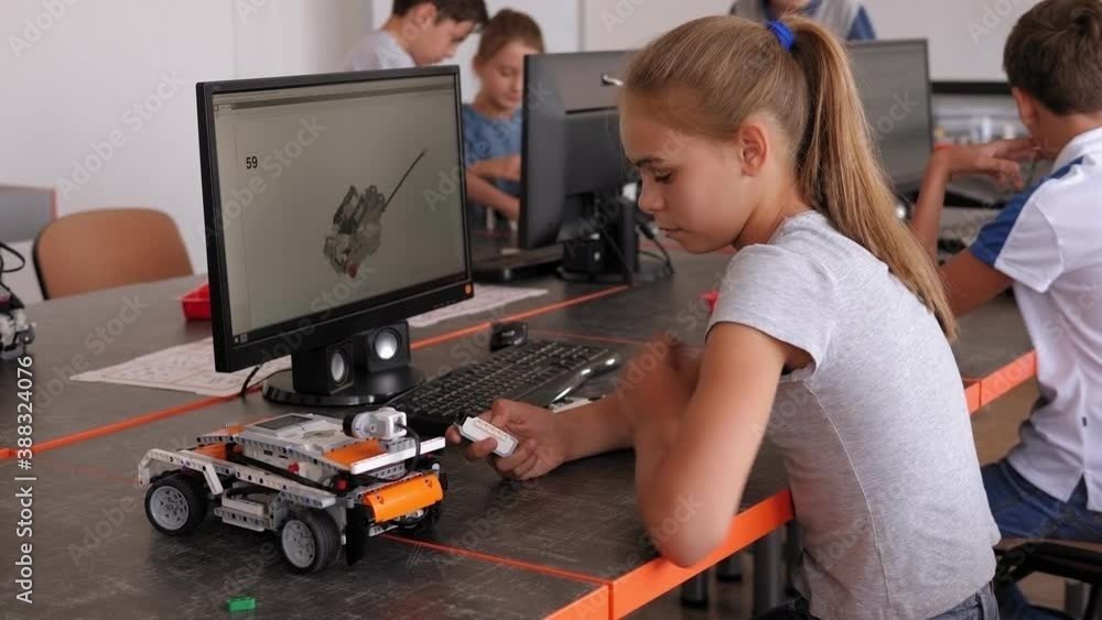 Group of kids building robot constructor from the plastics details ...
