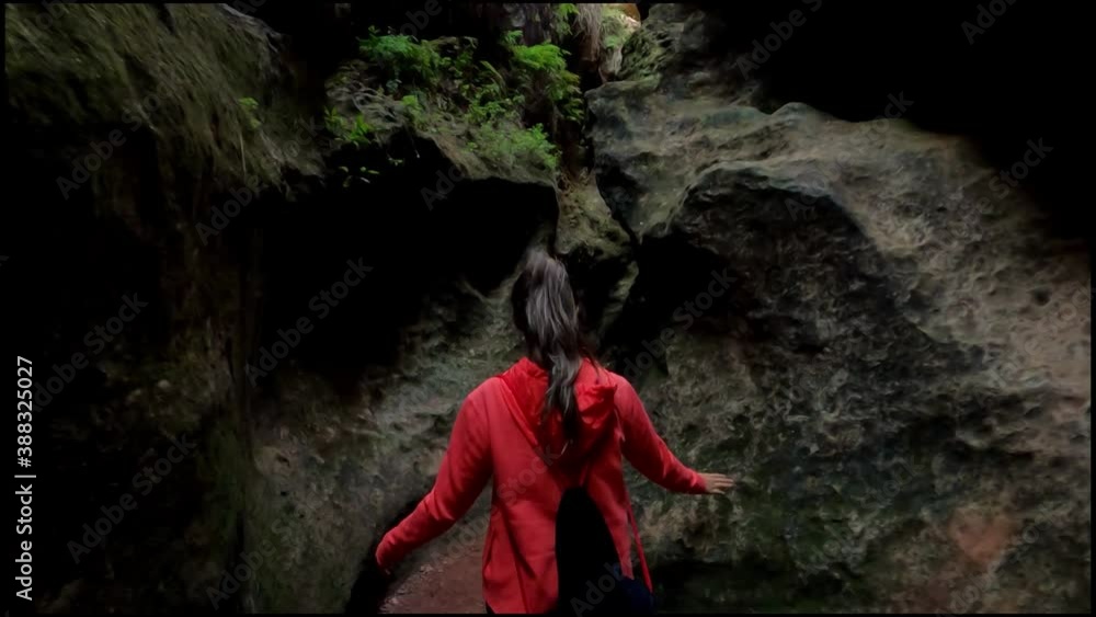 Cave exploration, exploring a cavern. Young explorer walks through a ...