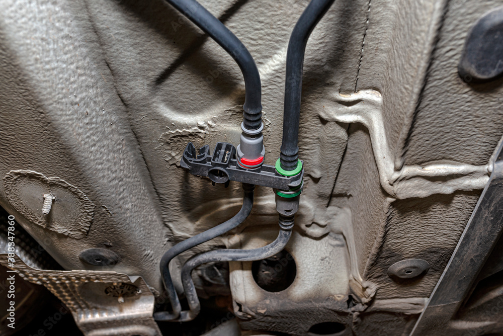 Black fuel lines mounted under the cars chassis, view from the bottom ...