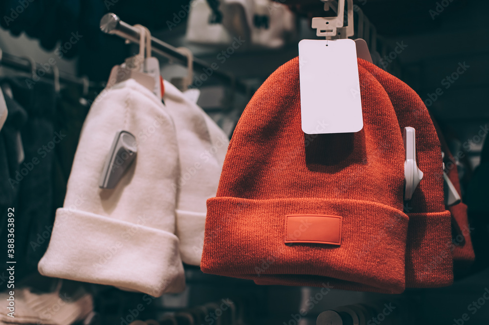 Close-up, modern winter hats with label mockup, on a supermarket ...