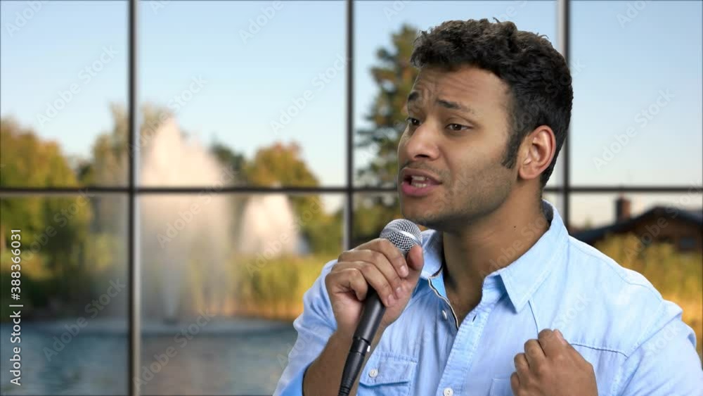 Video Stock Close up handsome performer singing into microphone ...