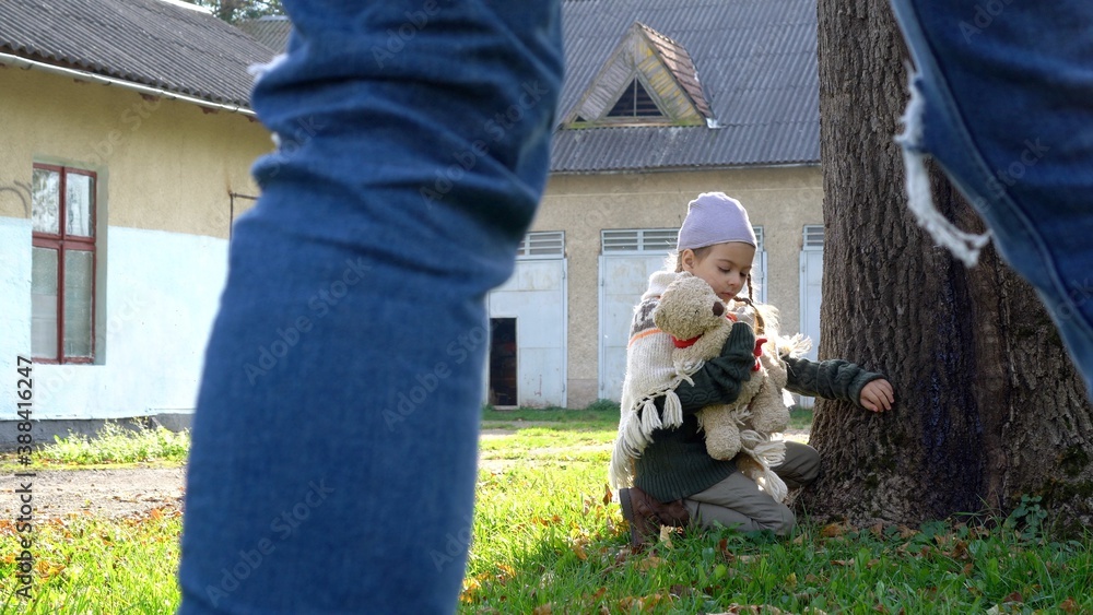 Mistreated child. Little girl with teddy bear is scared. Child in ...
