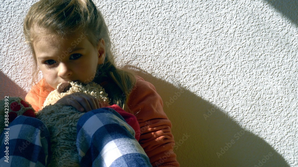 Mistreated child. Little girl on the floor sad. Child abuse concept ...