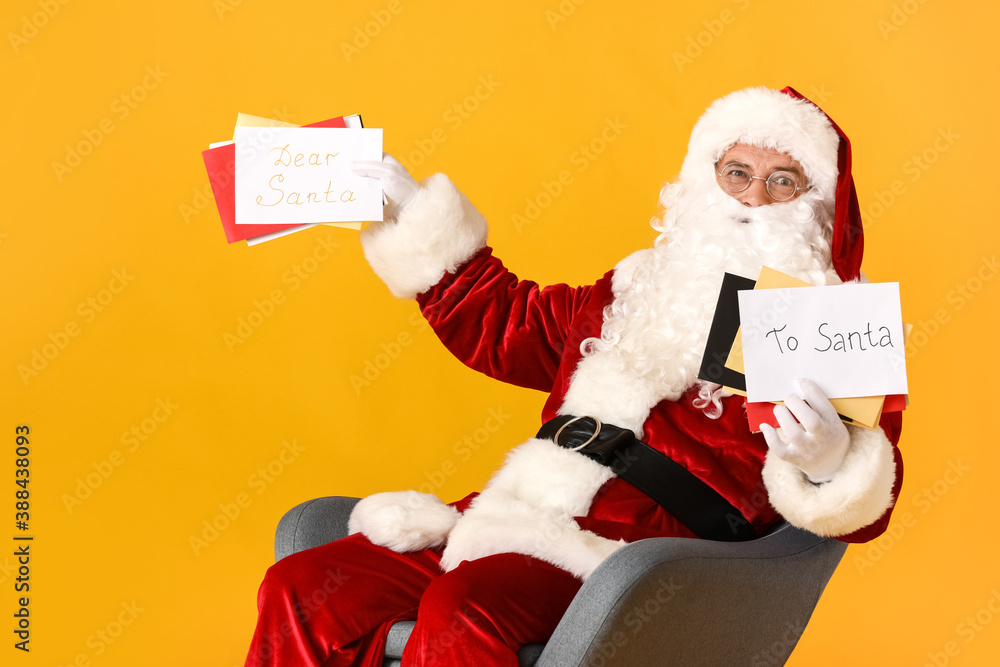 Santa Claus reading letters on color background Stock Photo | Adobe Stock