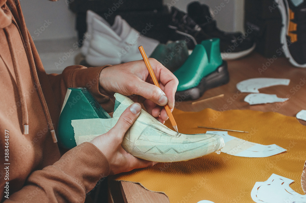 Shoemaker drawing a pattern on the shoe model Stock Photo | Adobe Stock