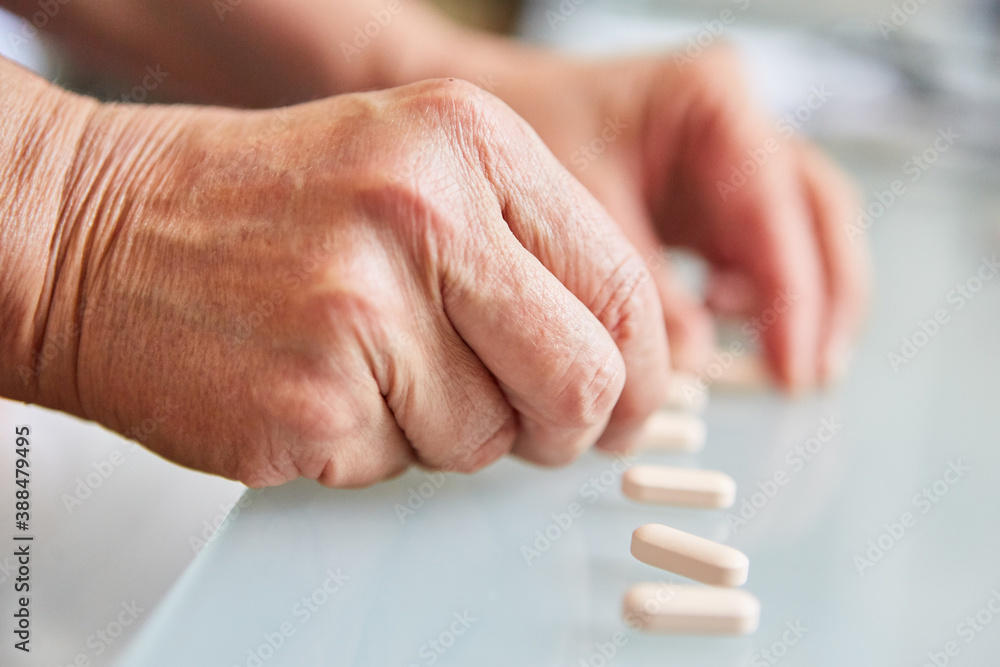 Hand von Senior legt Tabletten in eine Reihe Stock Photo | Adobe Stock