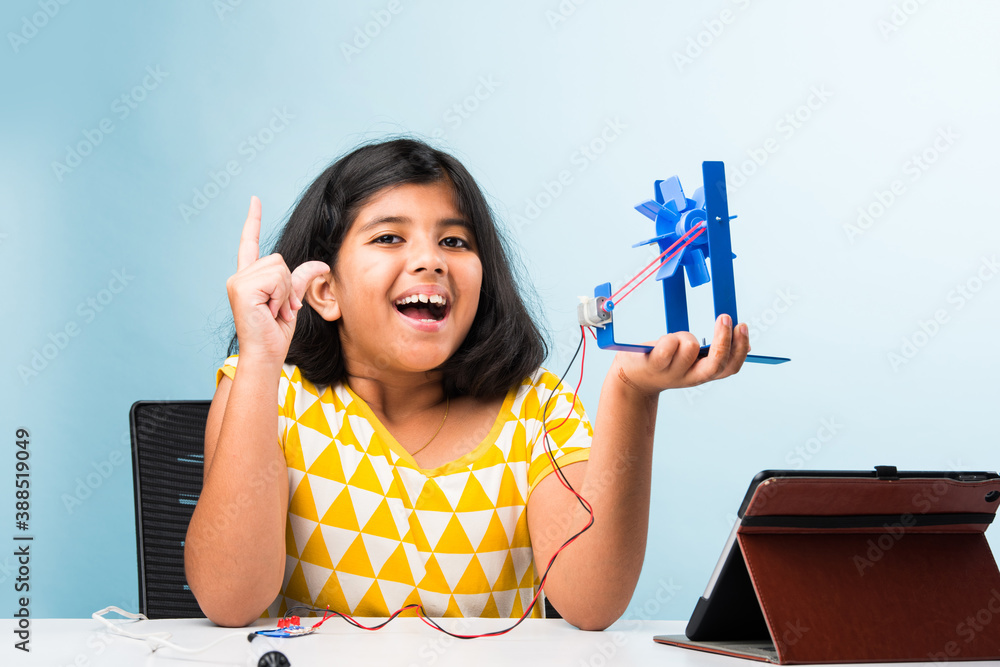 Electronic experiment - Indian girl student working with wires and ...