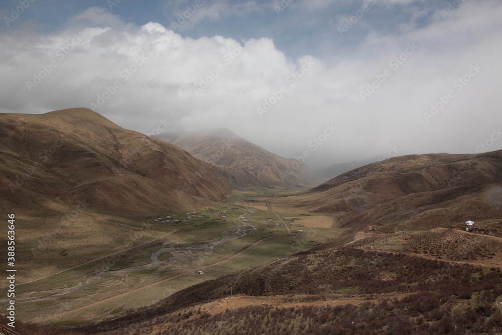 Larung valley under misty fog at The Serta Larung Five Science Buddhist ...