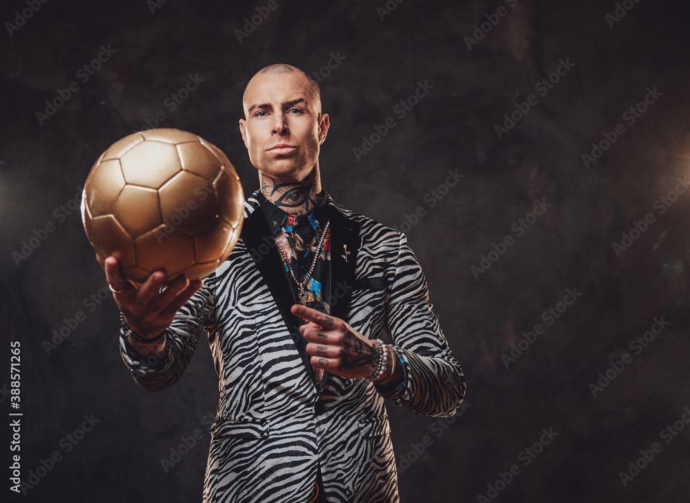 Handsome and stylish coach in custom suit with tattoo and jewellery ...