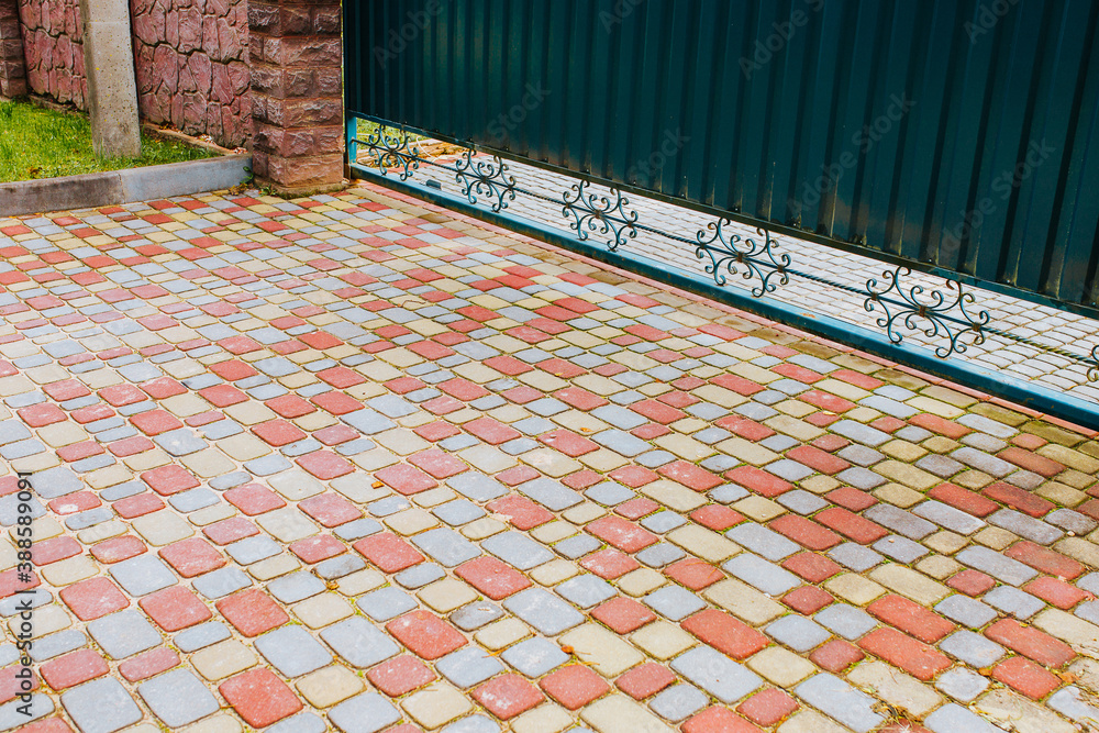 Multi-colored paving slabs on the ground in the courtyard of a private ...