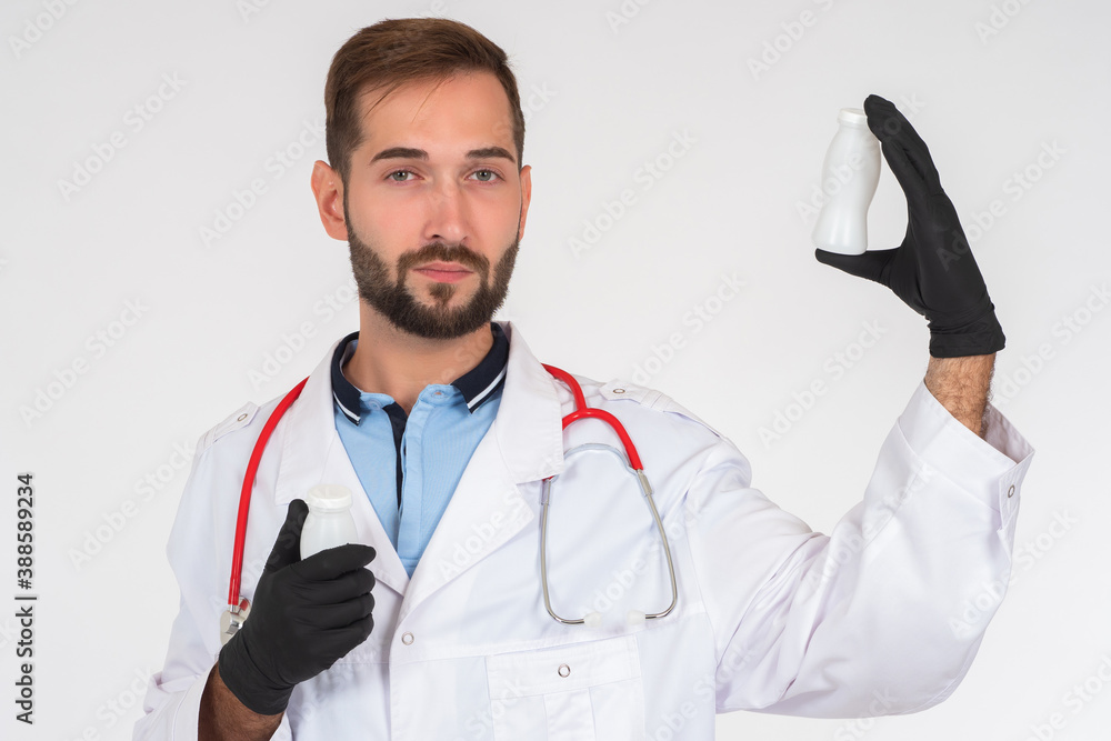 Biologist with white bottles in his hands. A man in a doctor's uniform ...